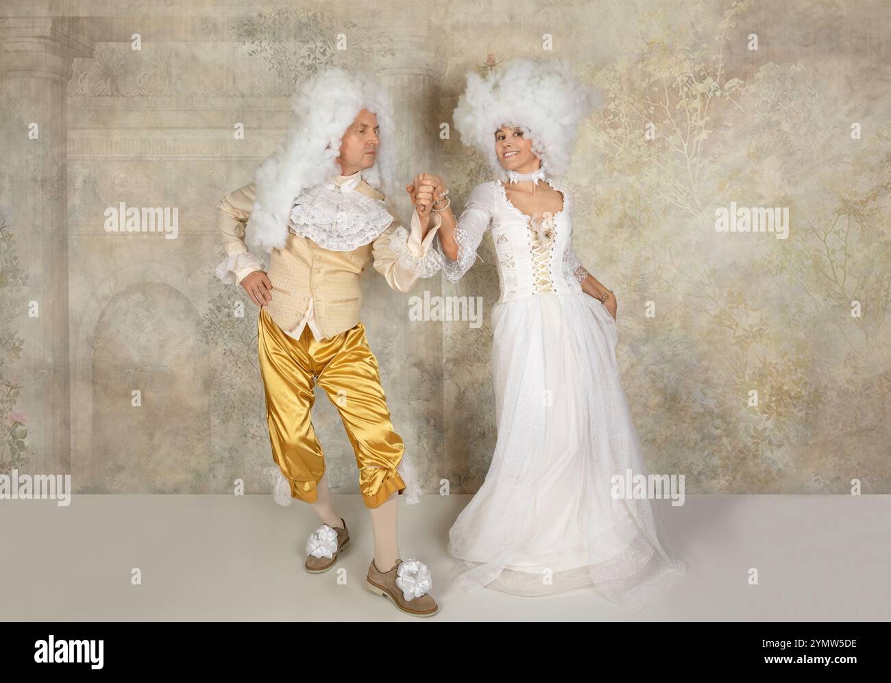 Funny couple in white wigs and Baroque style clothes dancing in the ...
