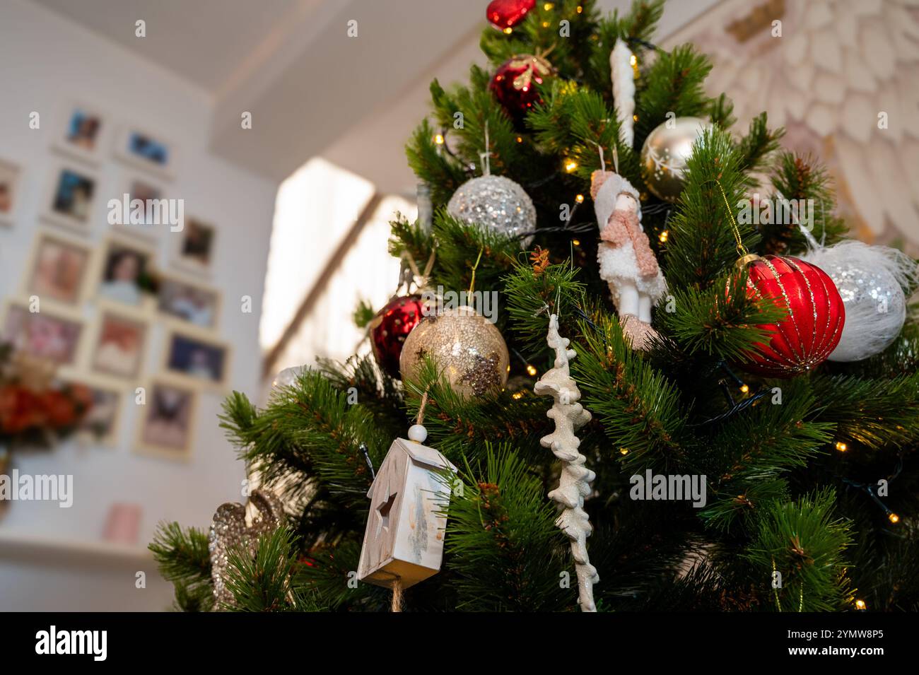 A Christmas tree with many ornaments and a bird ornament. The tree is ...