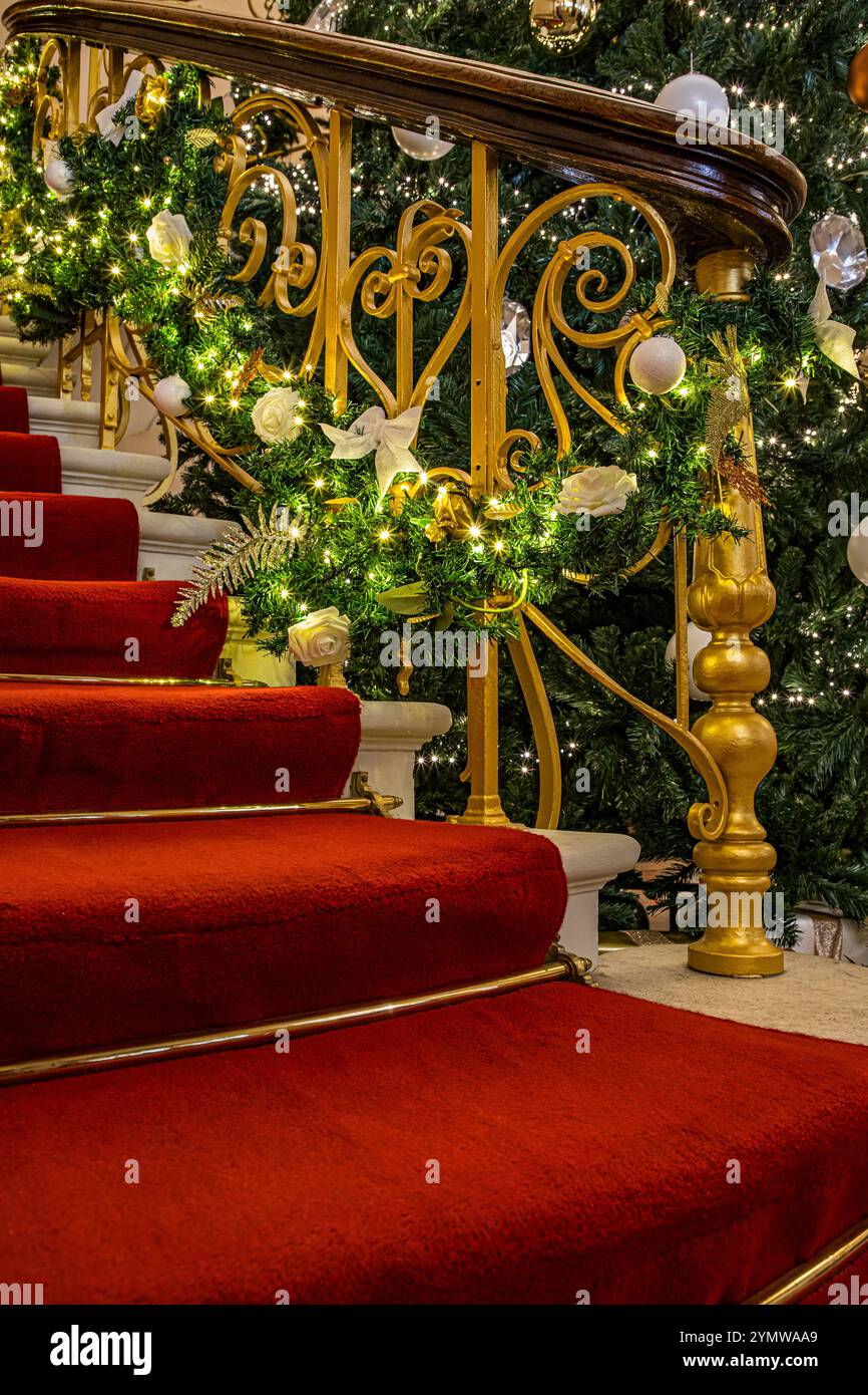 Christmas image of a red carpeted stone stairway and gold bannister ...