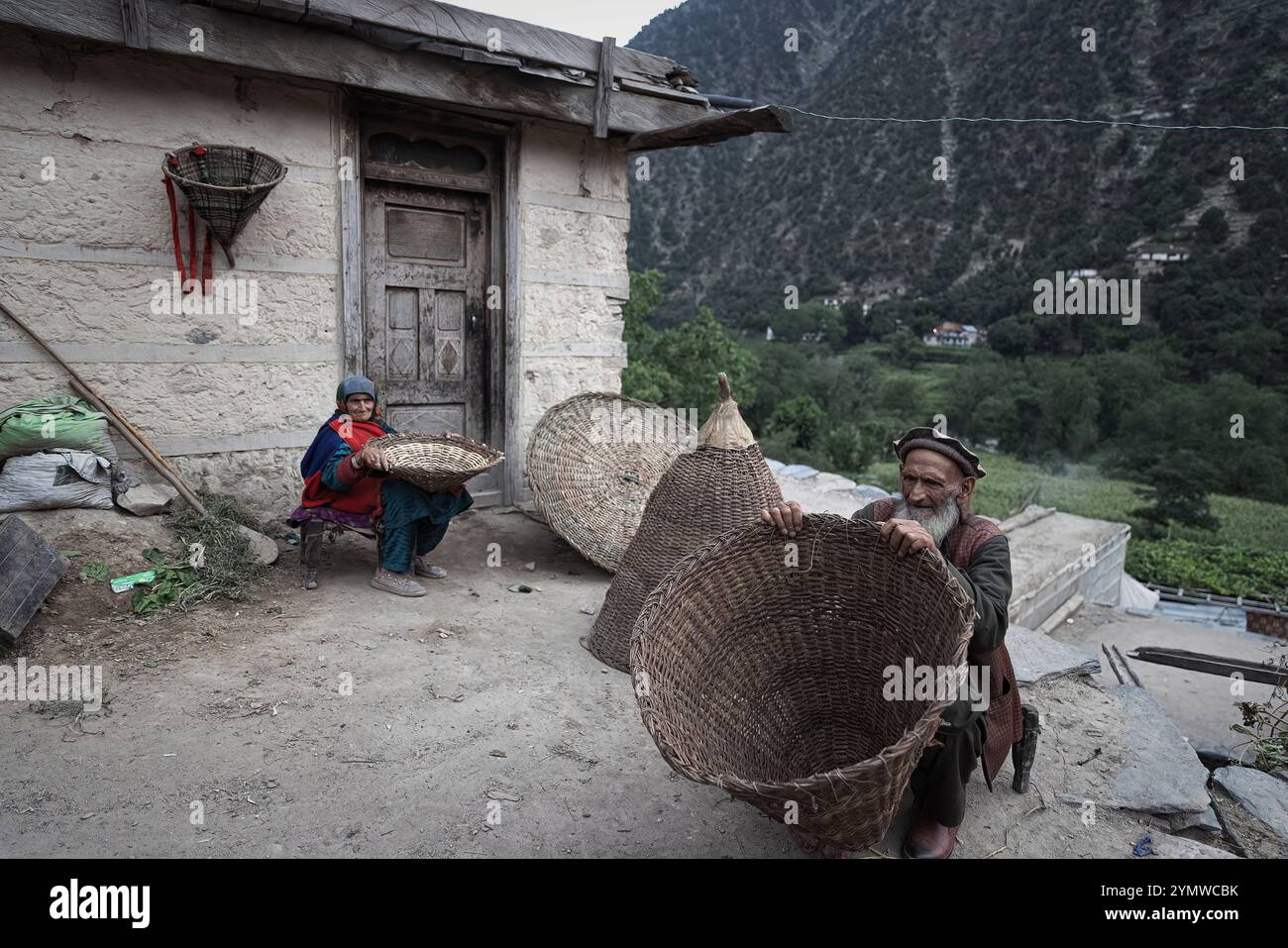A Nuristani woman and man weaving handmade baskets Nuristan ...