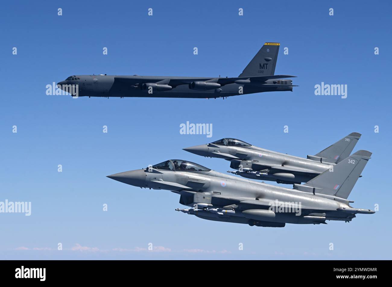 Two Royal Air Force Eurofighter Typhoons fly in formation with a U.S ...