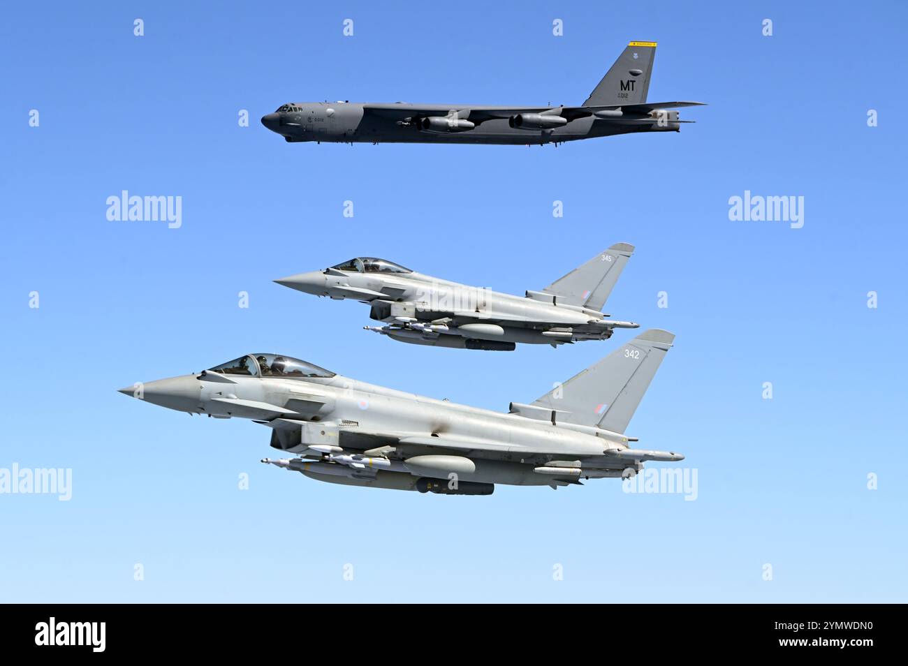 Two Royal Air Force Eurofighter Typhoons fly in formation with a U.S ...
