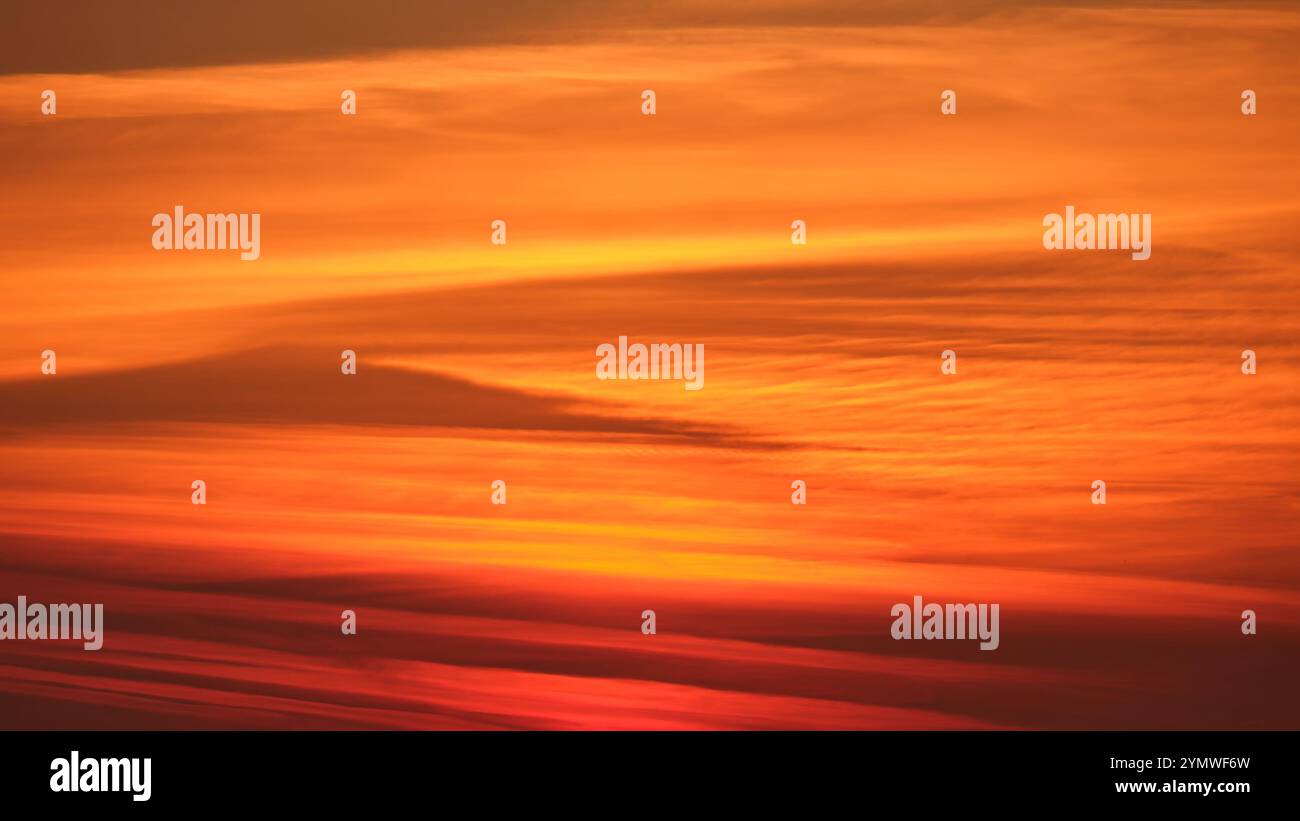 Abstract orange and red sunset sky with layered clouds. Nature ...