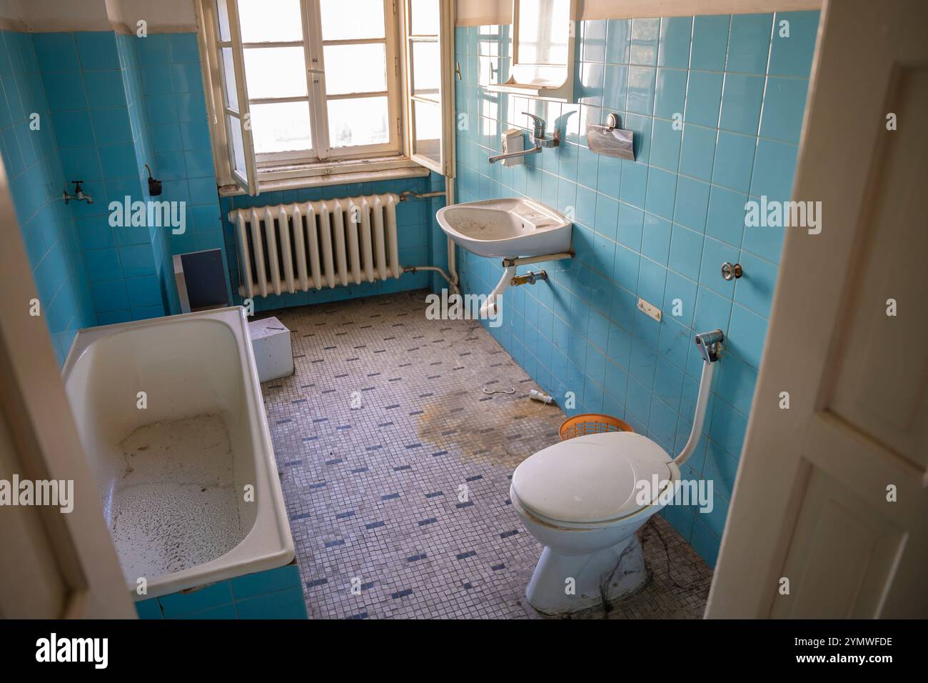 Abandoned old toilet in building destroyed, interior house. Blue tiles ...