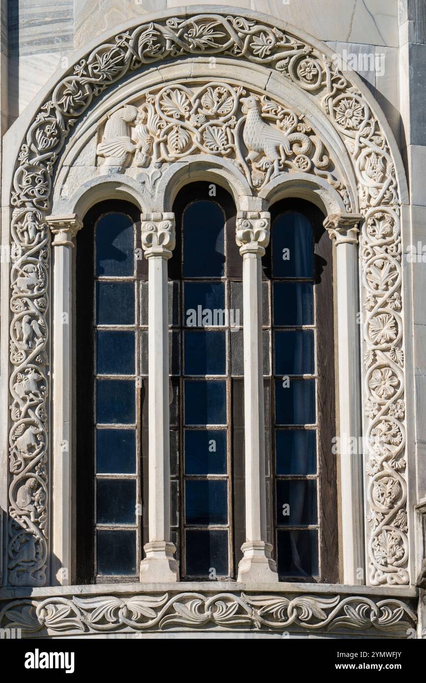 A marble wall with ornamented windows on sunlight of monastery ...