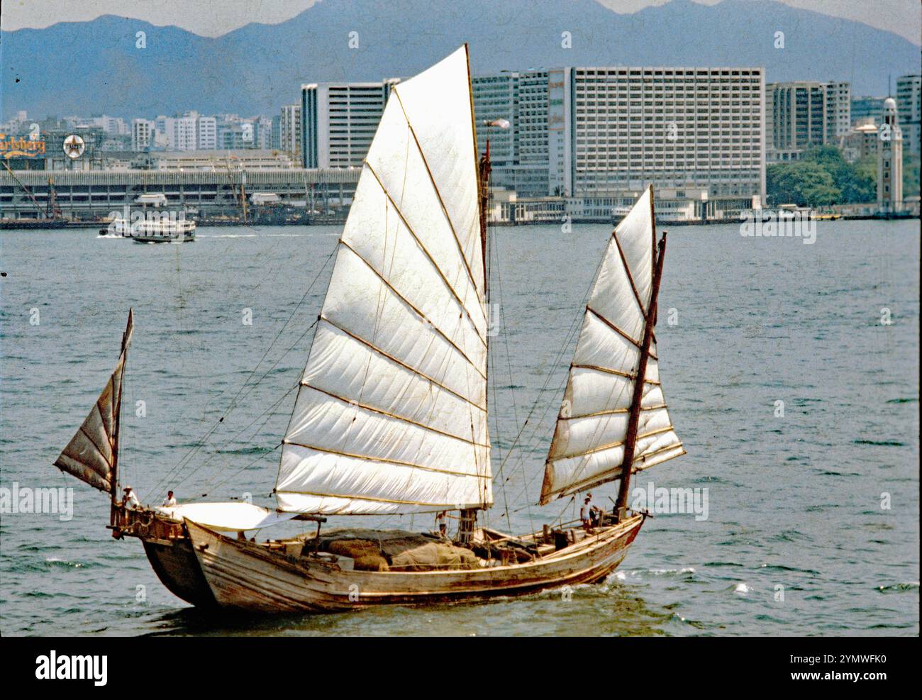 A traditional Chinese cargo junk tacks through the narrows between Hong ...
