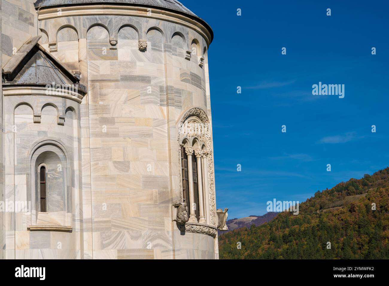 A marble wall with ornamented windows on sunlight of monastery ...