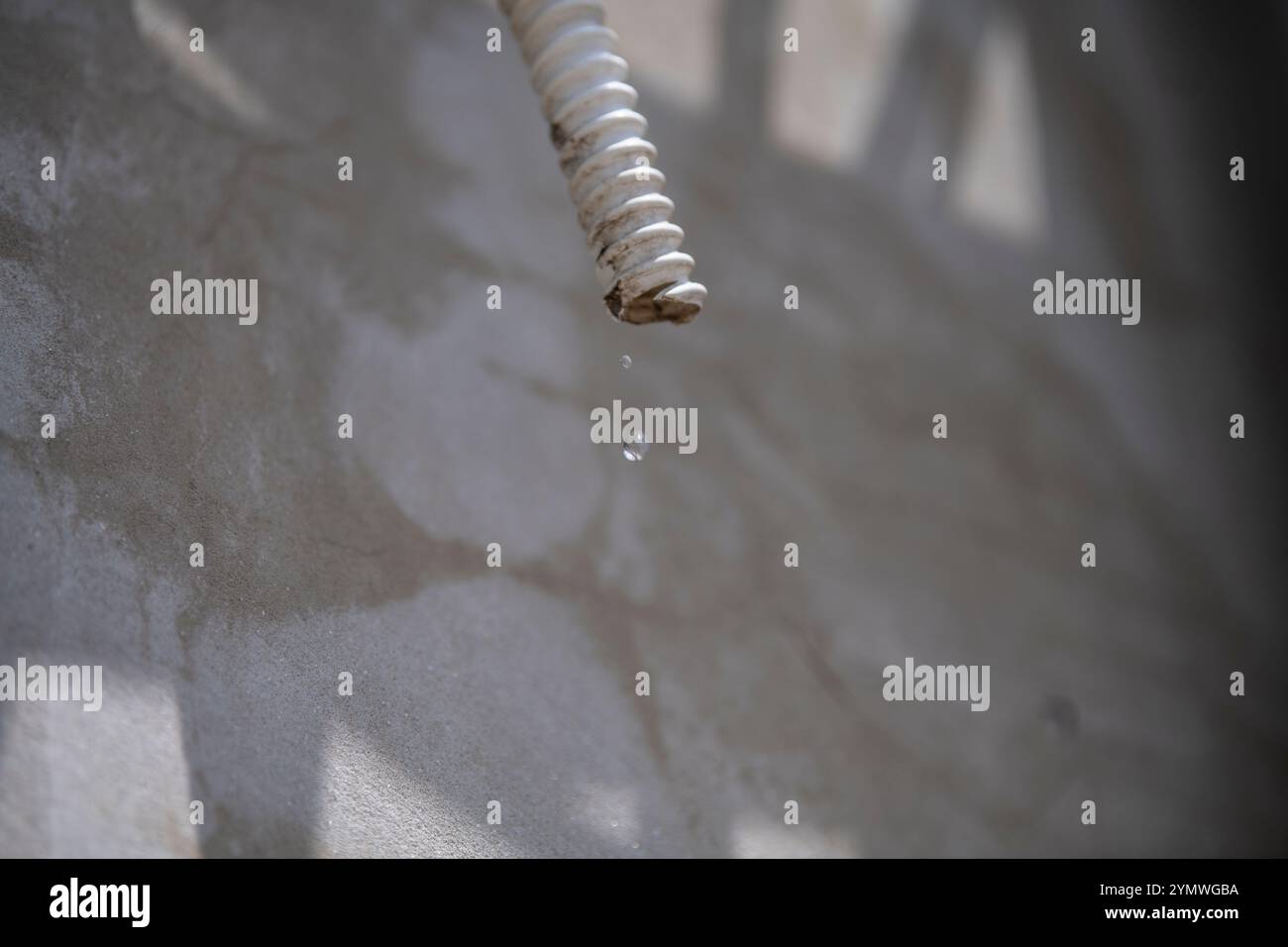 AC drain pipe dripping water on a wall Stock Photo - Alamy