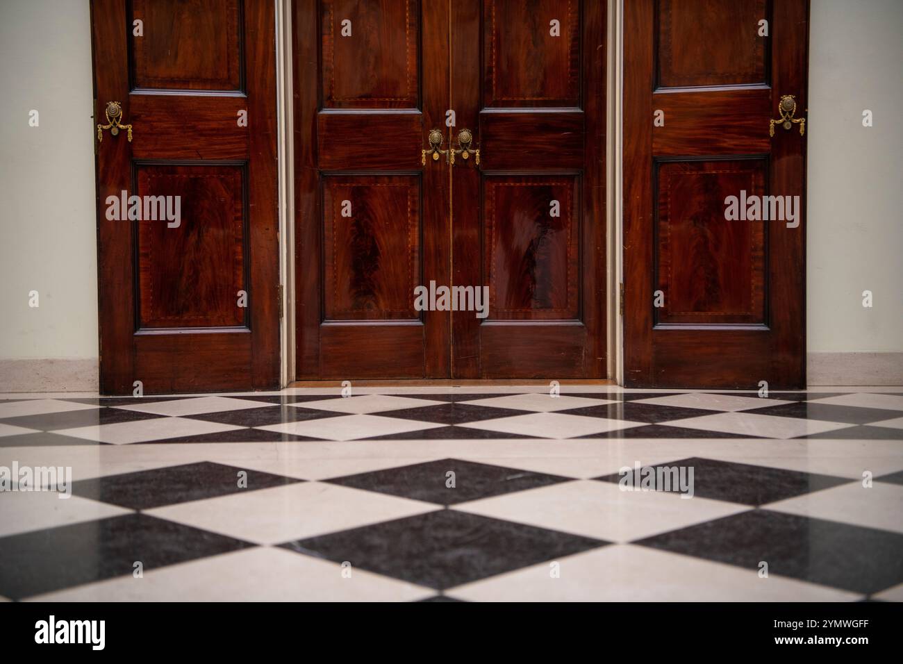 Wooden doors at the end of hall with black and white tails Stock Photo ...