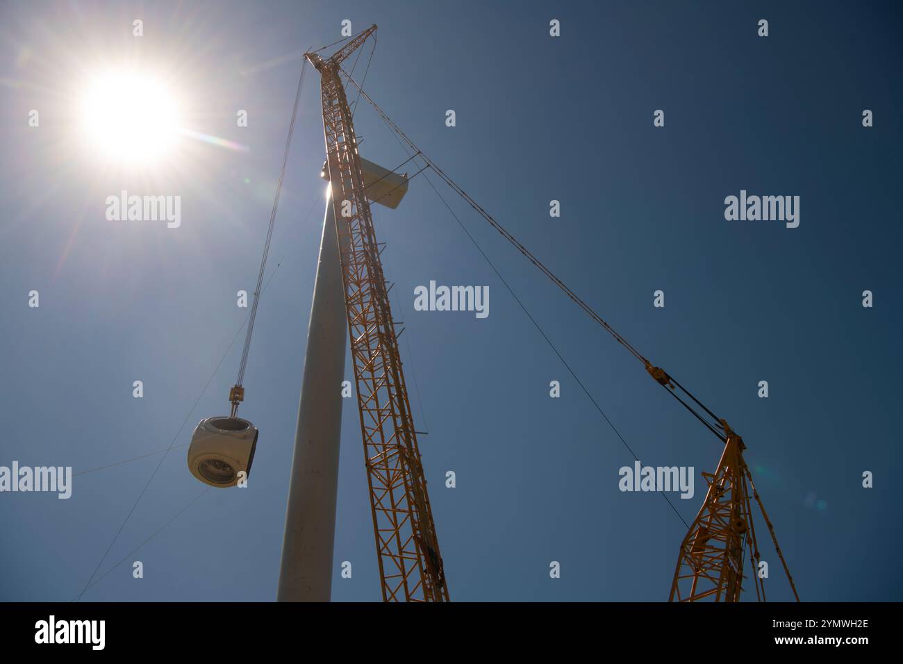Construction site on windmill farm with heavy machinery during day from ...