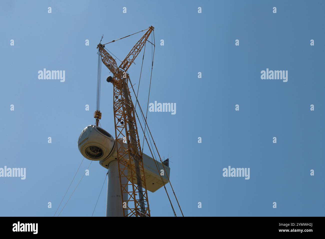 Construction site on windmill farm with heavy machinery during day from ...