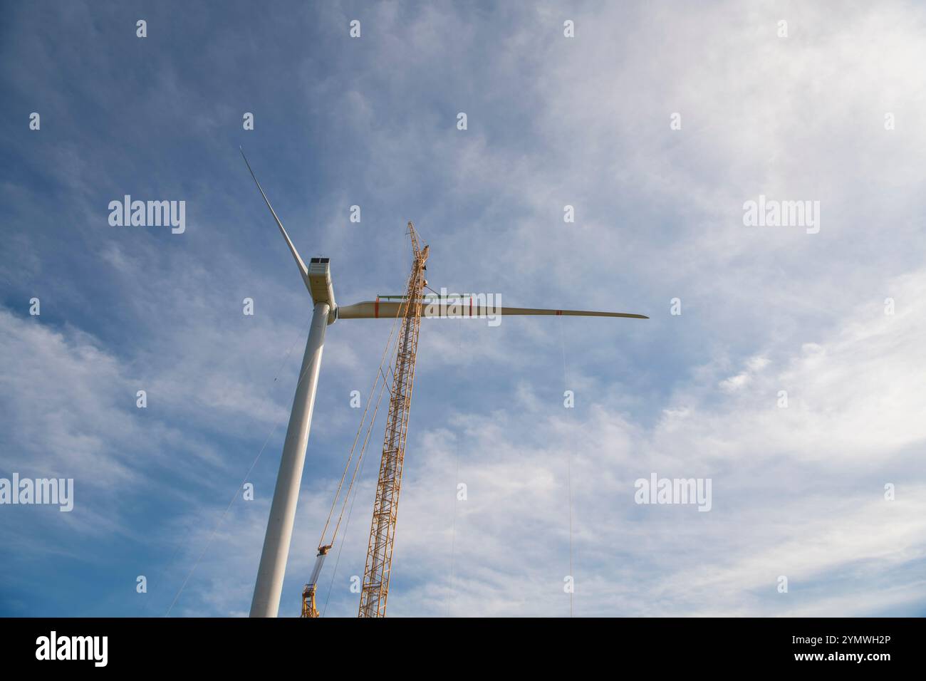 Construction site on windmill farm with heavy machinery during day from ...