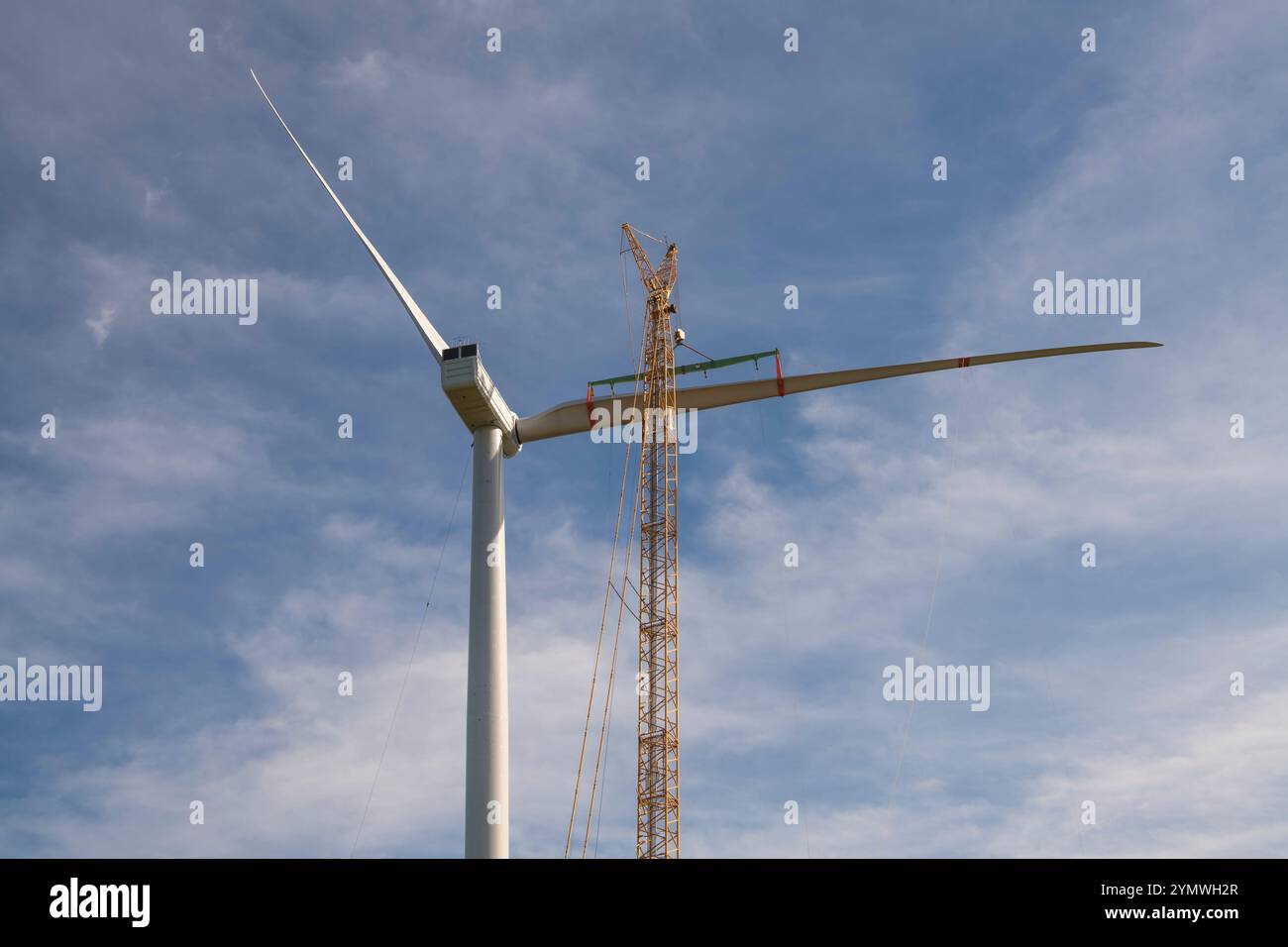 Construction site on windmill farm with heavy machinery during day from ...
