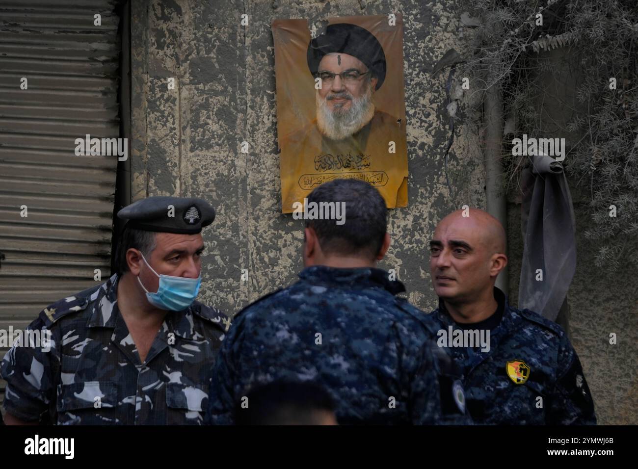 Lebanese police stand in front of a portrait shows the late Hezbollah ...