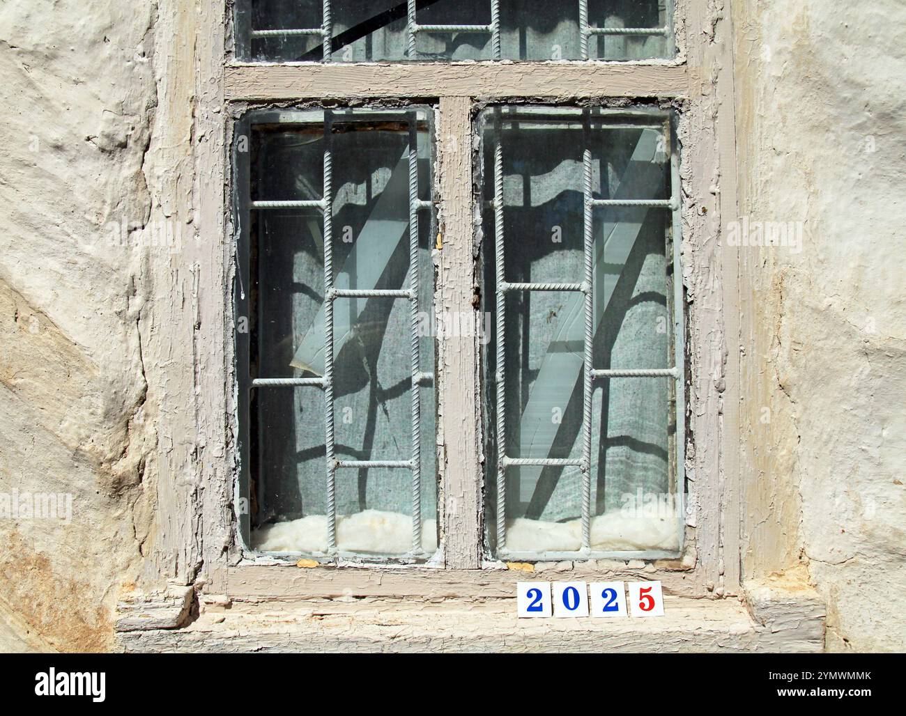 Numbers of 2025 year. Paper square numbers on the old wooden window ...