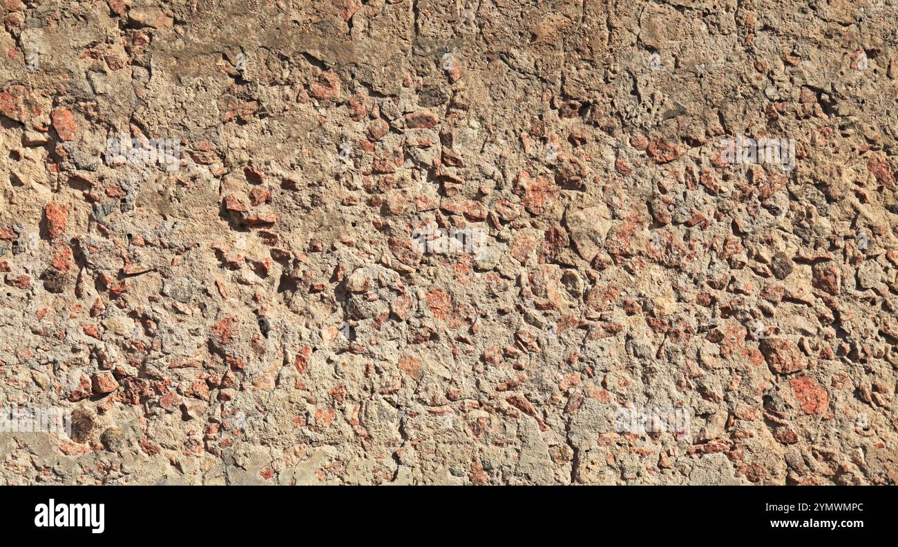 Rough wall. Concrete with a visible base of granite stones. An old ...