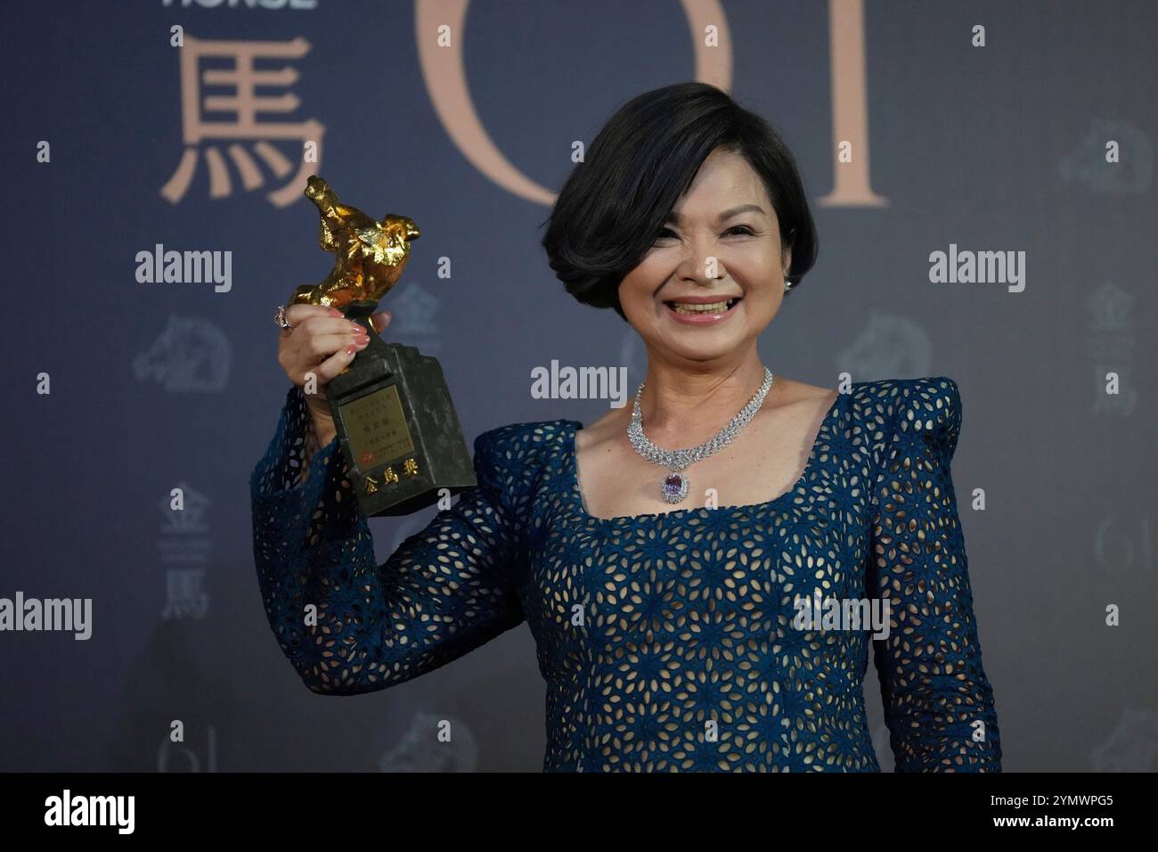 Yang Kuei-mei holds her award for Best Supporting Actress at the 61st Golden Horse Awards in ...