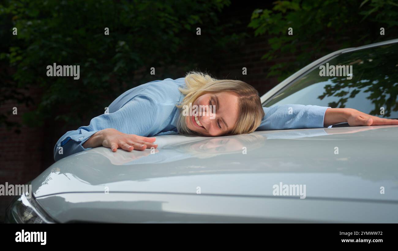 Cheerful satisfied Caucasian female automobile owner client woman girl ...