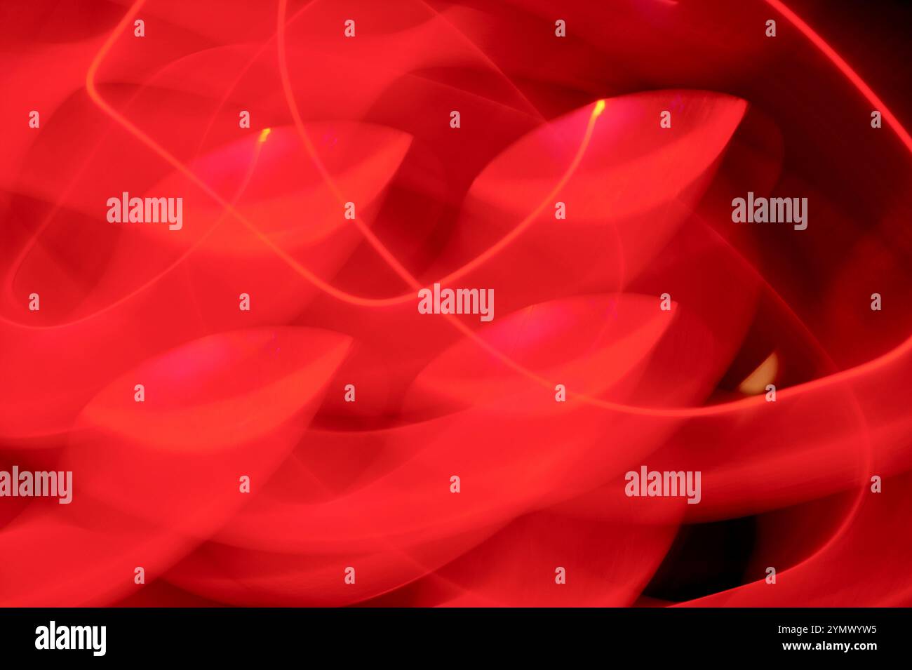 This Image Captures Abstract Red Light Trails Forming Intricate Circular Patterns On A Dark