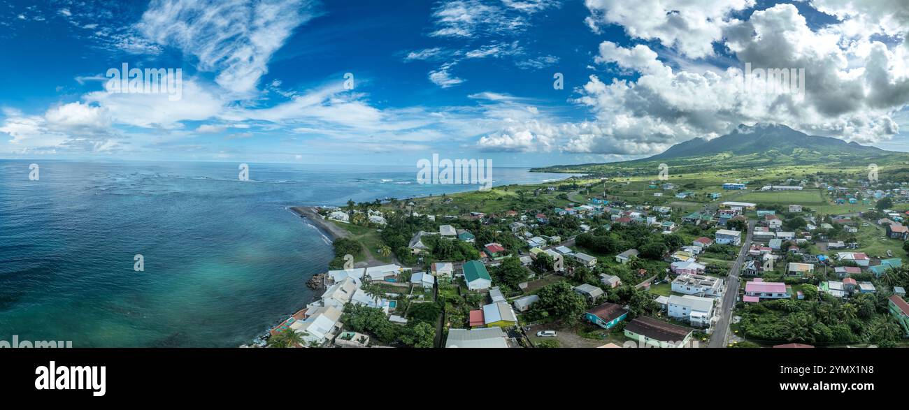 Aerial view of Sandy Point Town with volcano in St Kitts and Nevis ...
