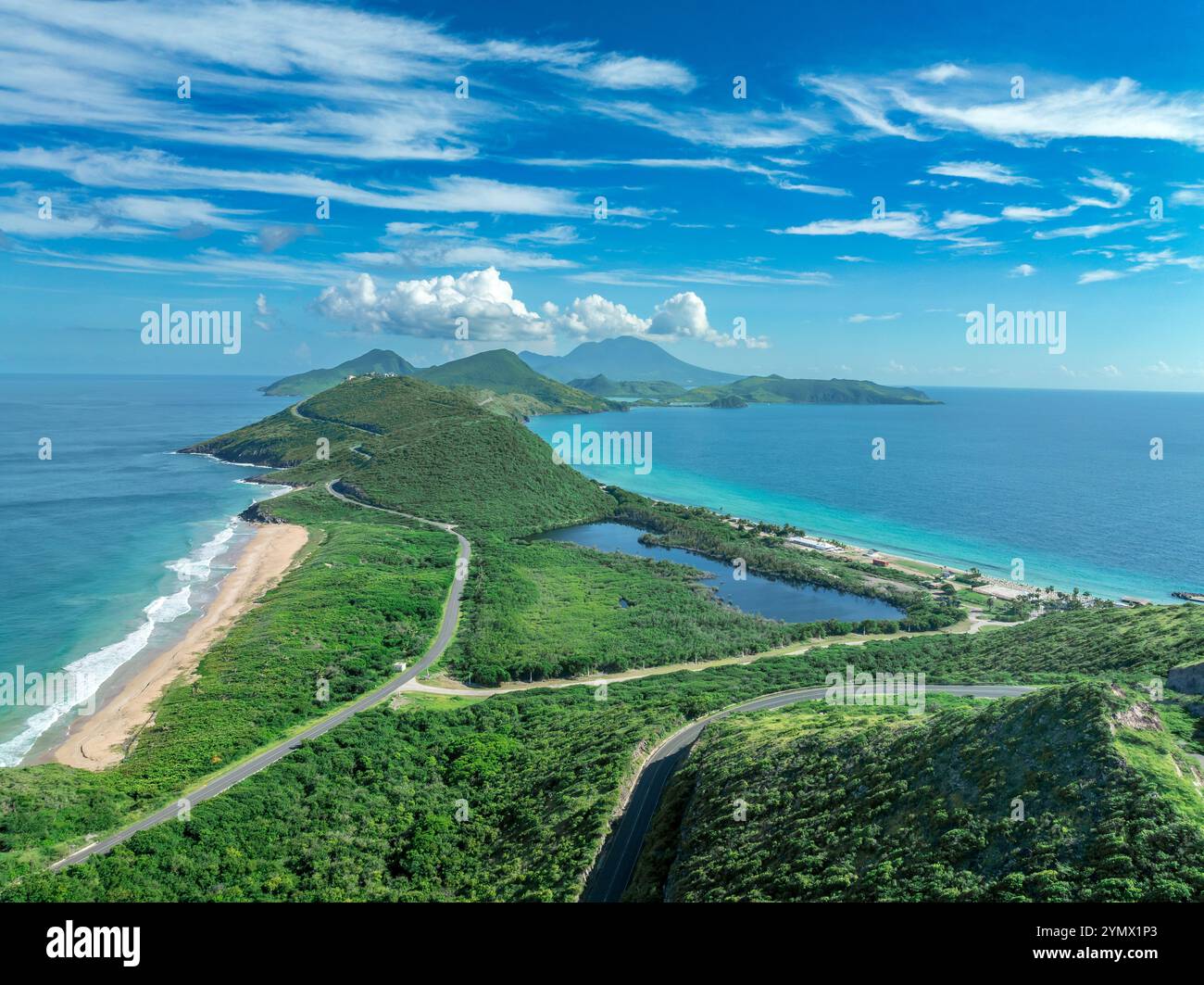 Aerial view of St Kitts shores with turquoise water Nevis peak in the ...
