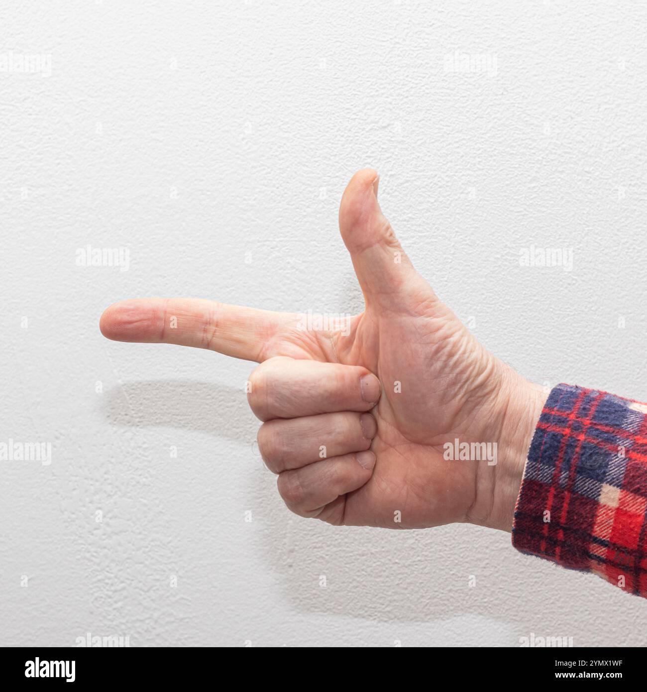 A man's hand clad in a red plaid shirt forms a number two gesture ...