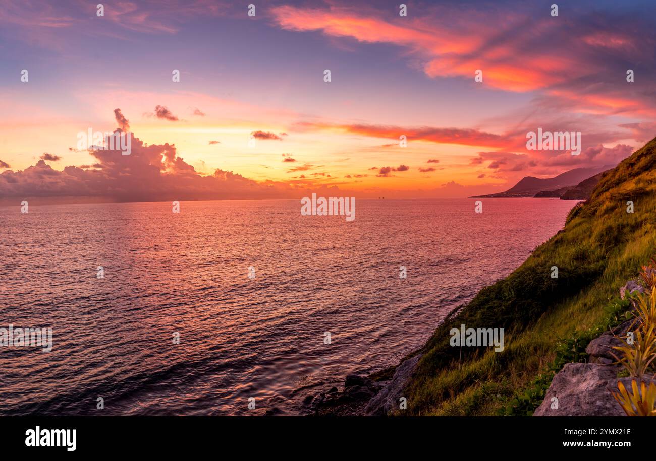 Stunning Caribbean sunset with orange, pink, purple sky in St Kitts and Nevis Stock Photo - Alamy
