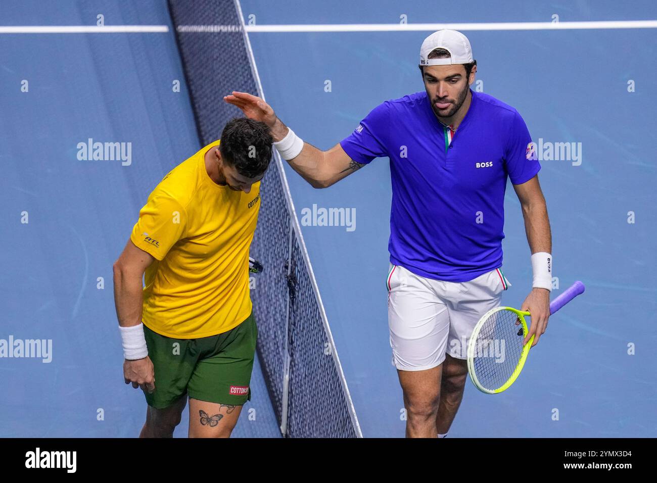 Italy's Matteo Berrettini, right, comforts Australia's Thanasi Kokkinakis after winning their ...