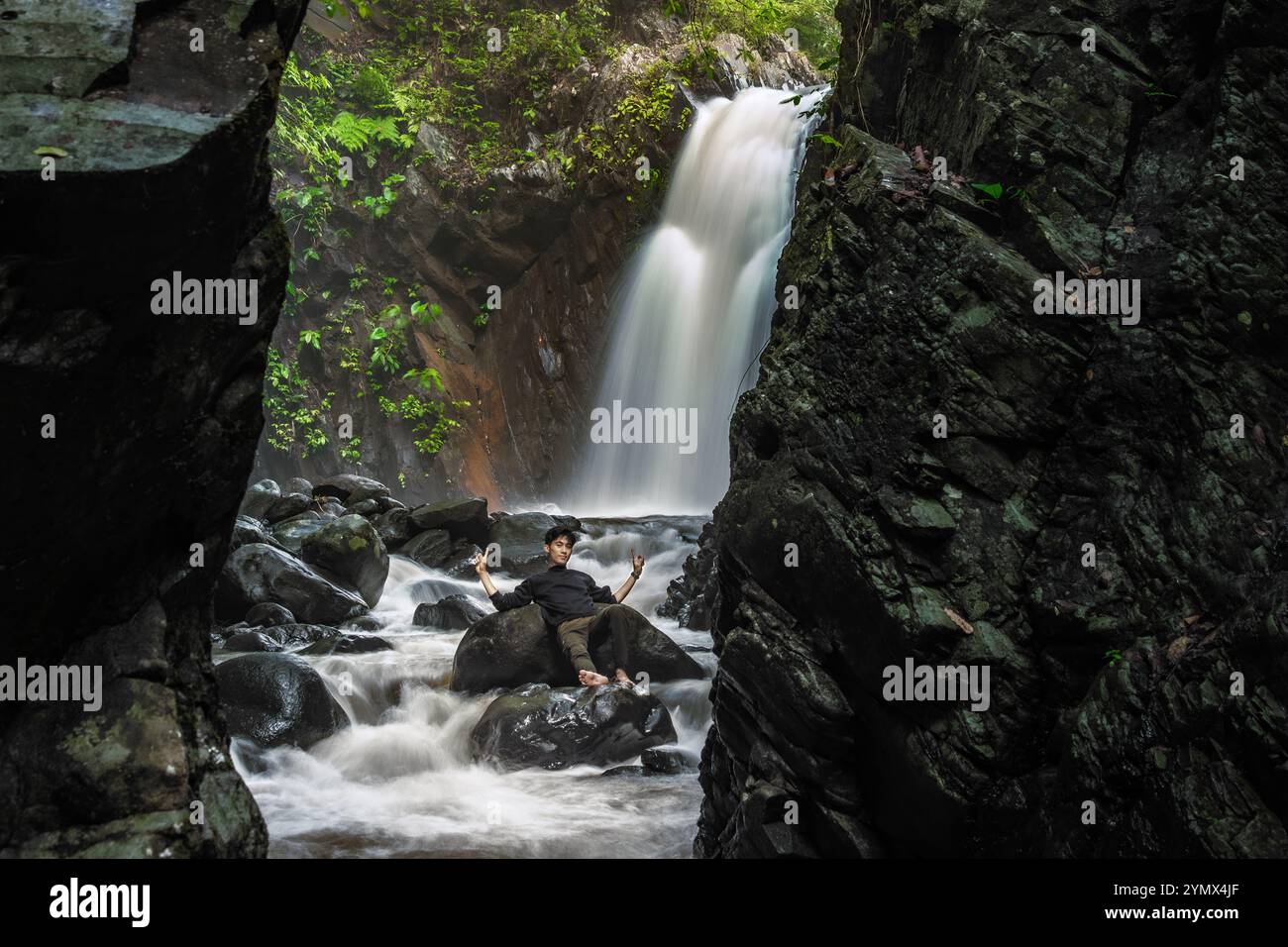 Proud man lying in the middle of river. Beautiful landscape with ...