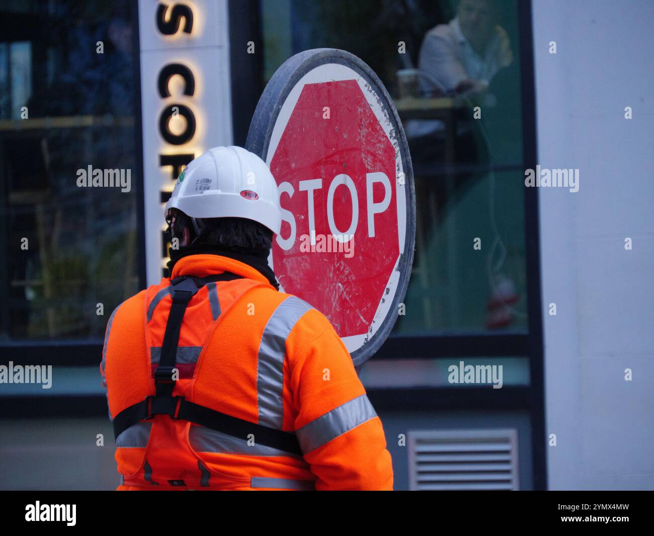 Banksman with stop traffic sign directing Broadgate London UK Stock ...