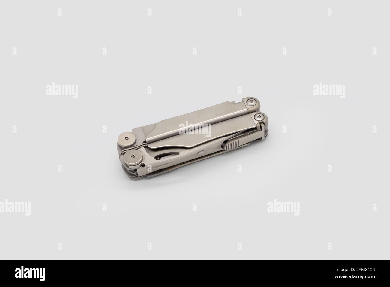 Stainless steel multitool designed for everyday carry, isolated on a ...