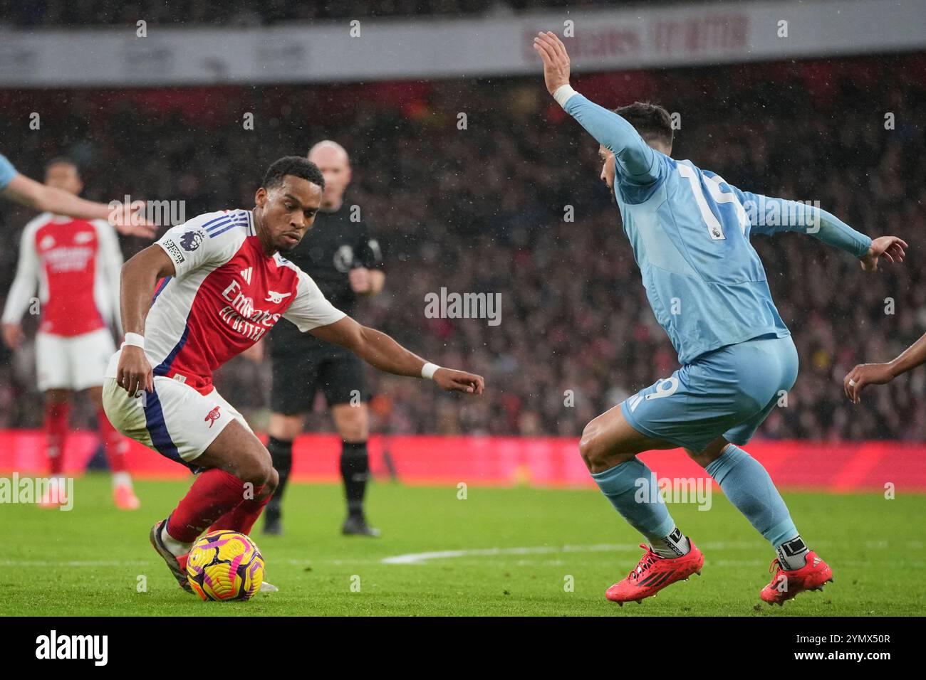 Arsenal's Jurrien Timber, left, duels for the ball with Nottingham ...