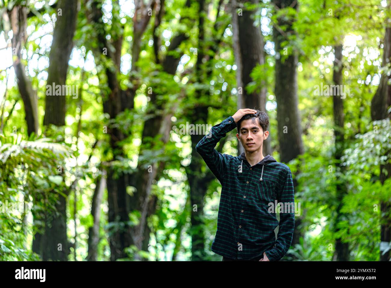 Handsome man standing alone while looking around in the middle of ...