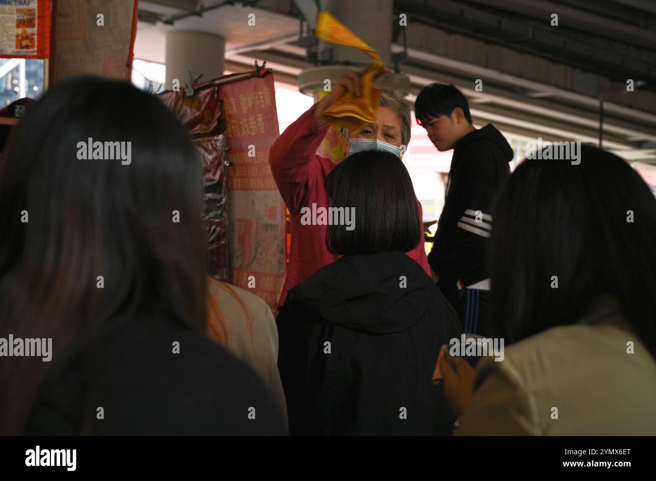 Hong Kong, China. 23rd Nov, 2024. A practitioner waves Taoist magic writing paper ceremony over ...