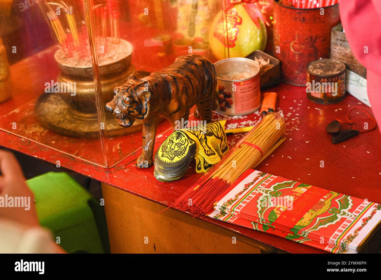 Hong Kong, China. 23rd Nov, 2024. A yellow paper tiger, incenses and ...