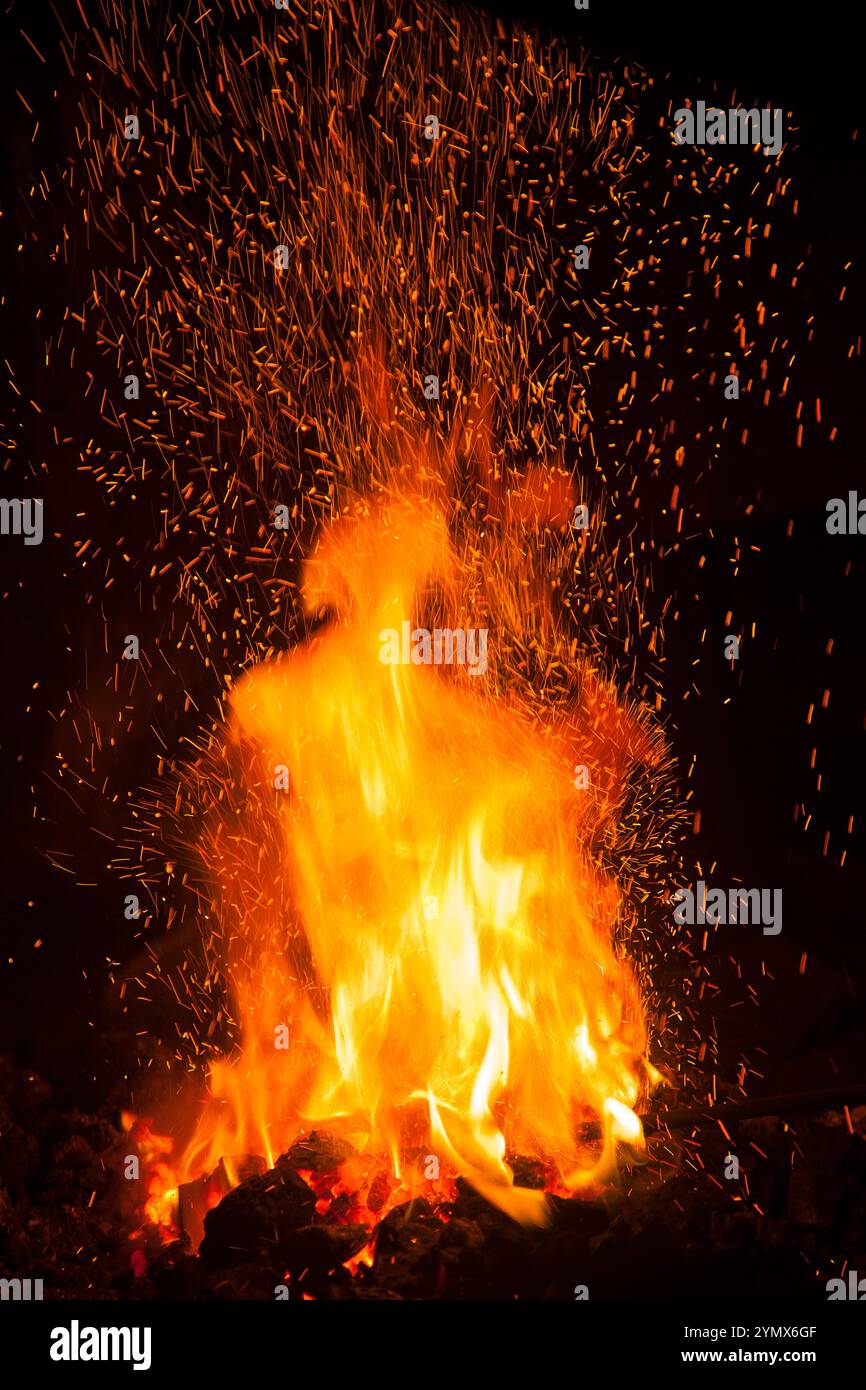 fire with sparks in the dark Stock Photo - Alamy
