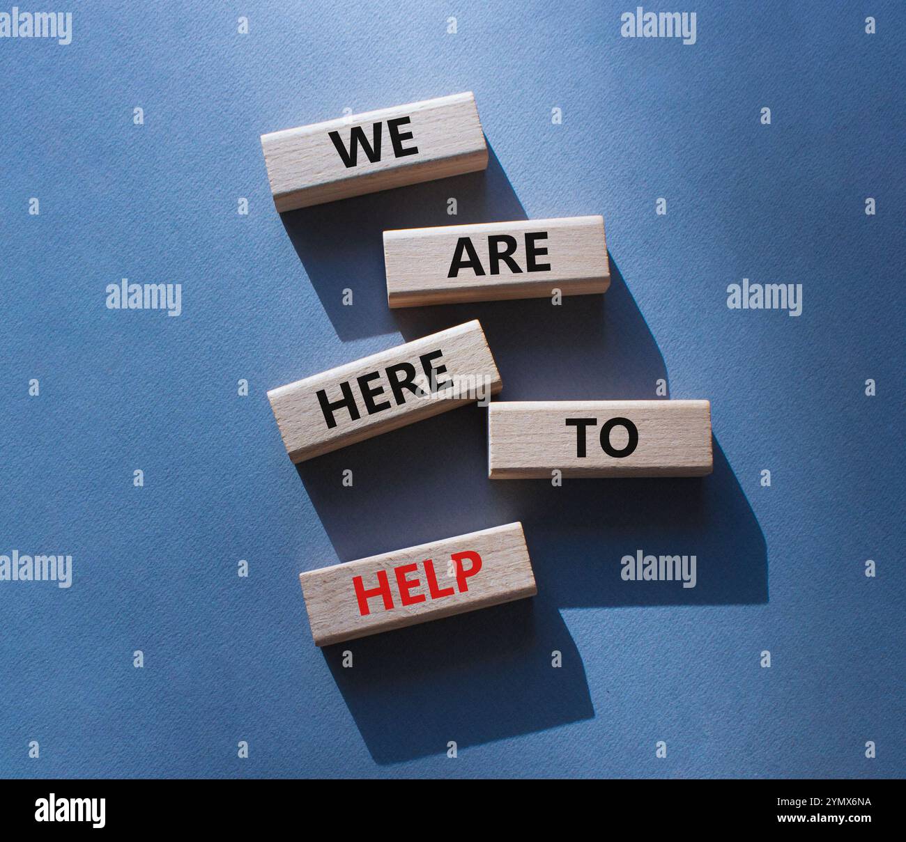 We are here to help symbol. Concept words we are here to help on wooden ...