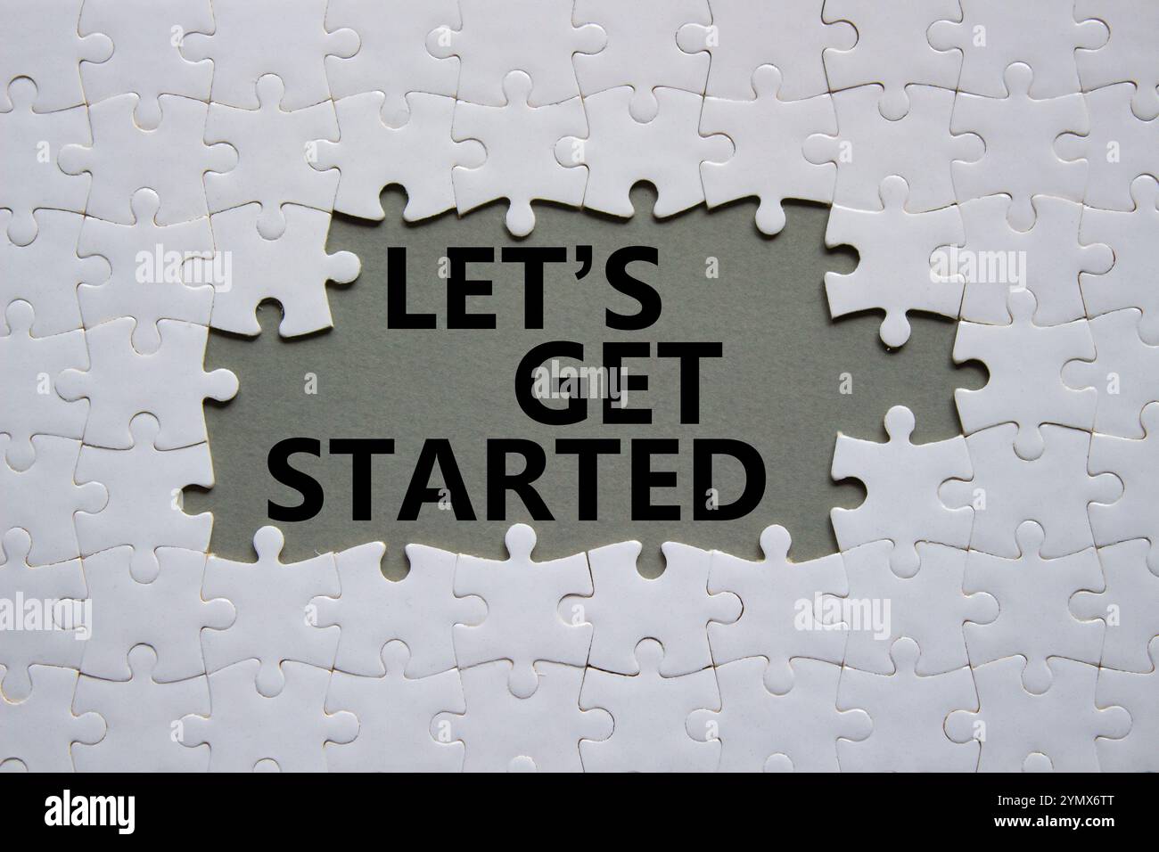 Lets get started symbol. Concept words Lets get started on white puzzle ...