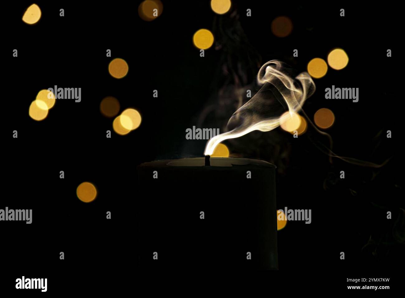 Smoke from an extinguished candle on a dark background with Christmas ...