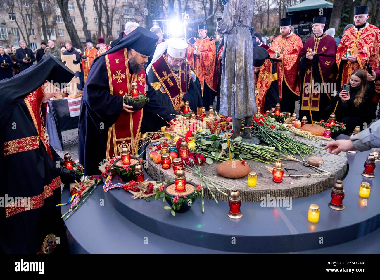 Priests seen placing down candles during prayer service held on ...
