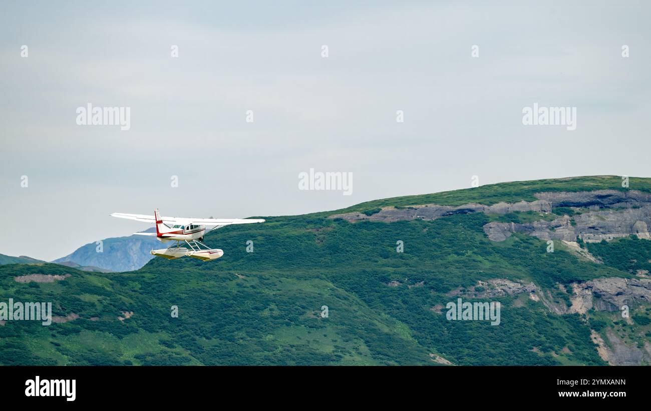 Alaskan bush plane flies over grass hills Stock Photo - Alamy