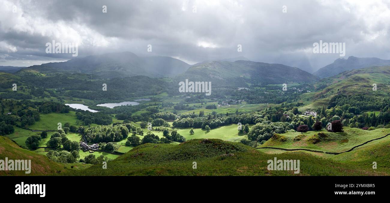 Light breaking through clouds onto farm land below Loughrigg Fell, Lake ...