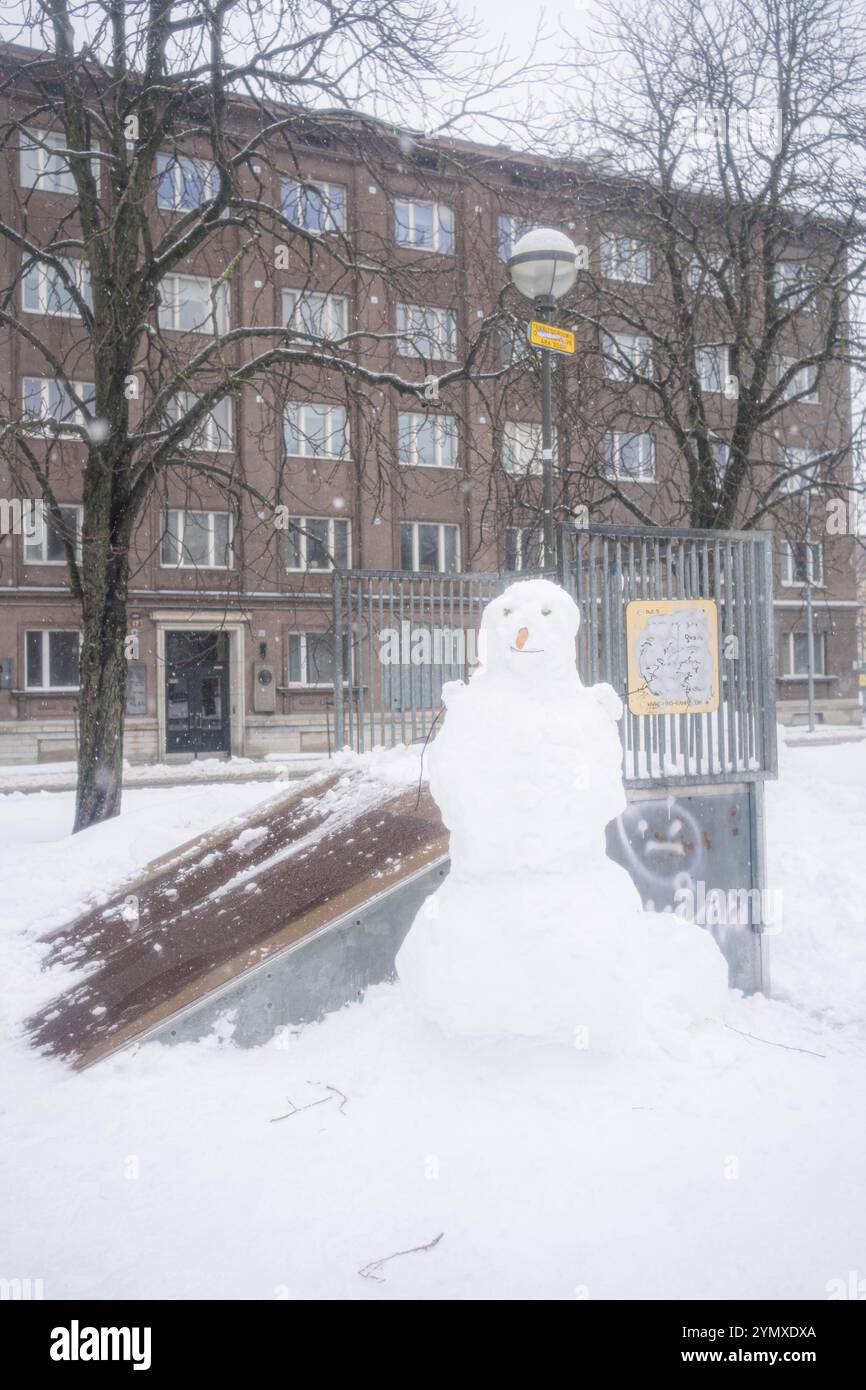 Funny snowman built by kids Stock Photo - Alamy