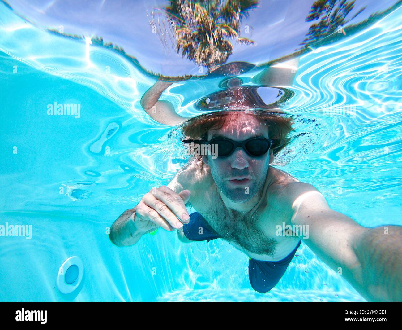 A man taking a selfie in an outdoor swimming pool in Italy. Photo ...