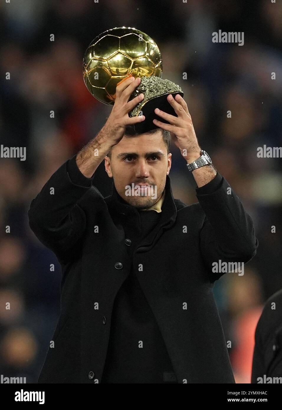 Manchester City's Rodri poses with the Ballon d'Or trophy before the ...