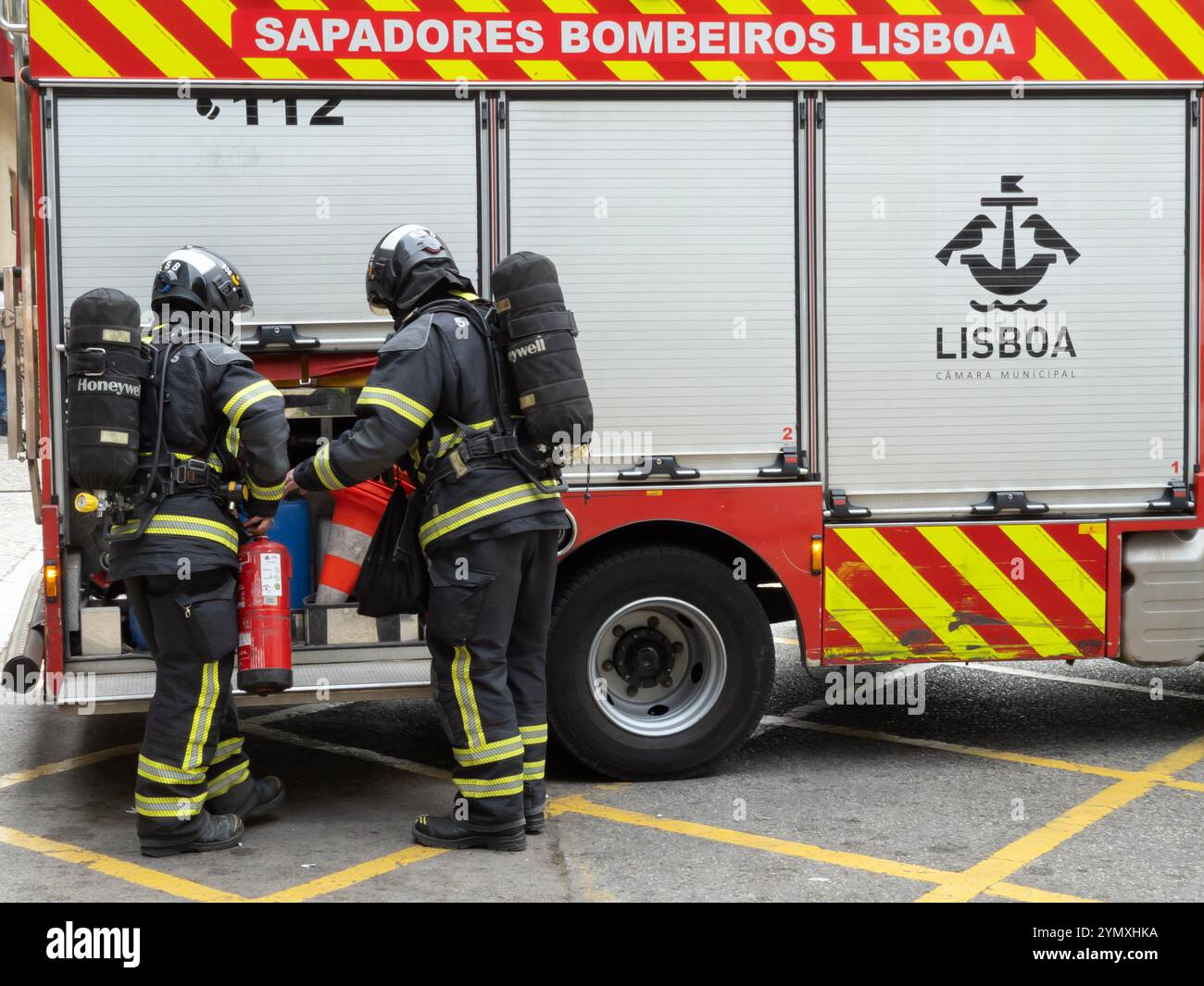 Lisbon, Portugal - June 9, 2024: Firefighters team taking extinguishers ...
