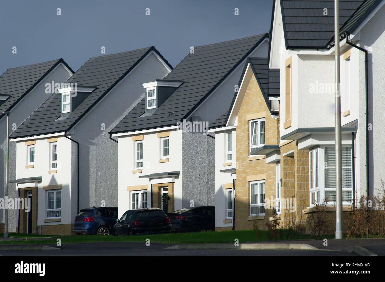 New housing development under dark storm clouds Stock Photo - Alamy