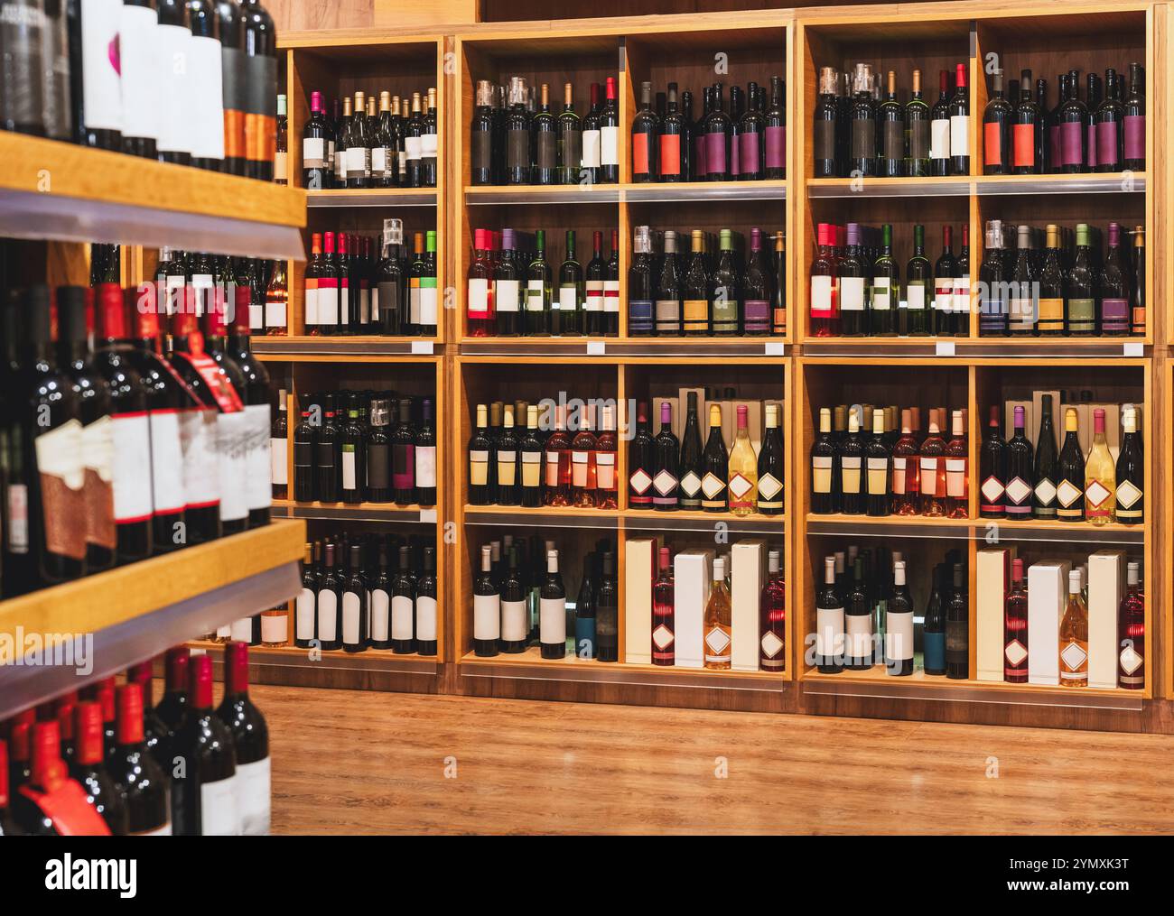 Wine bottles on the retail display in liquor store. Wine shop ...