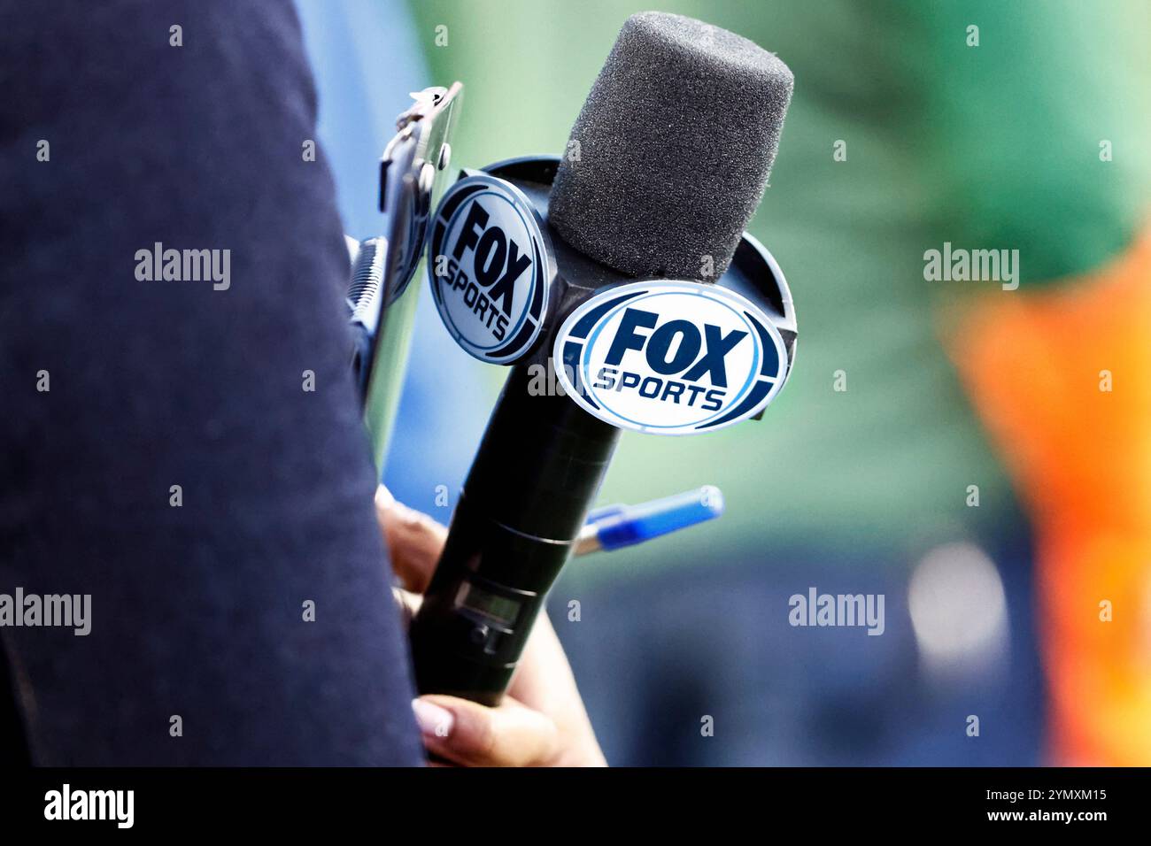 The Fox Sports logo is seen on a microphone in the hand of a sideline ...