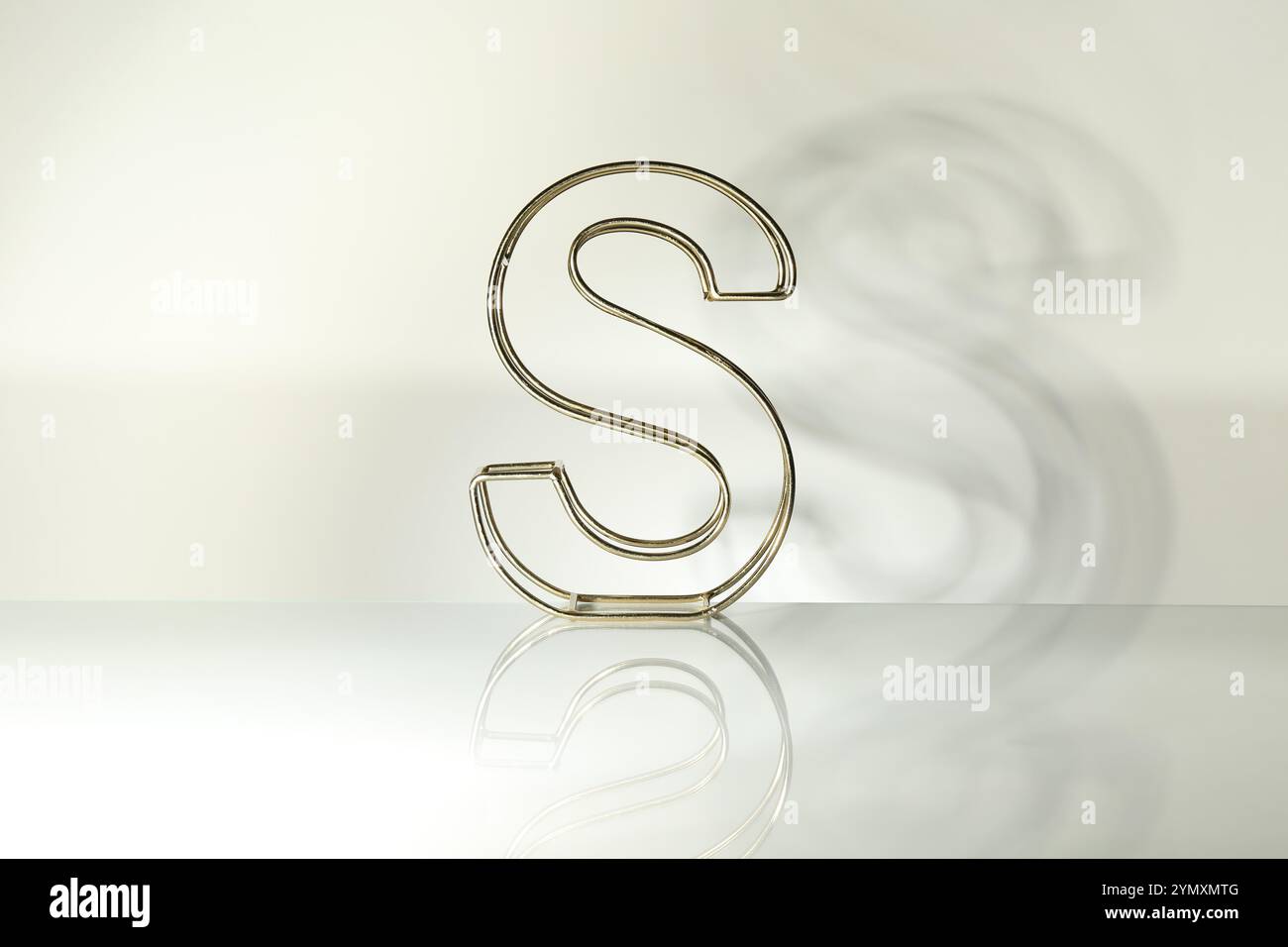 Stylish golden decor in shape of letter S on white background Stock ...